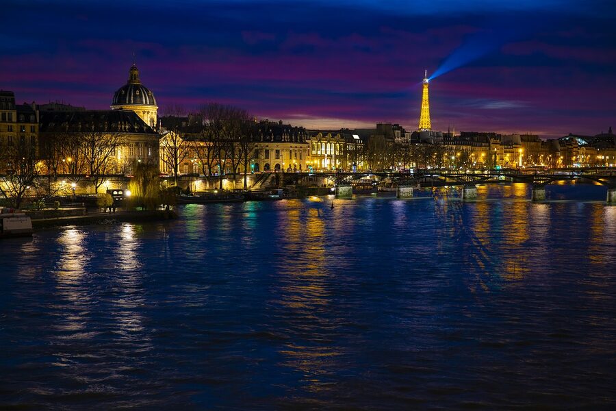 Paris night Seine reflections of bridge and buildings