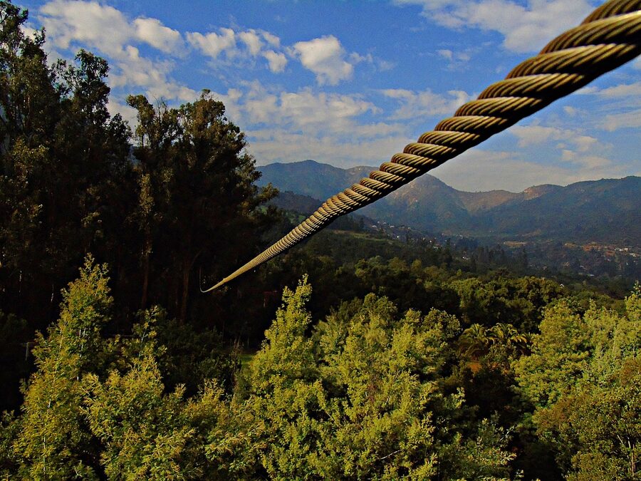 Forest canopy zipline cable running over a mountain hillside