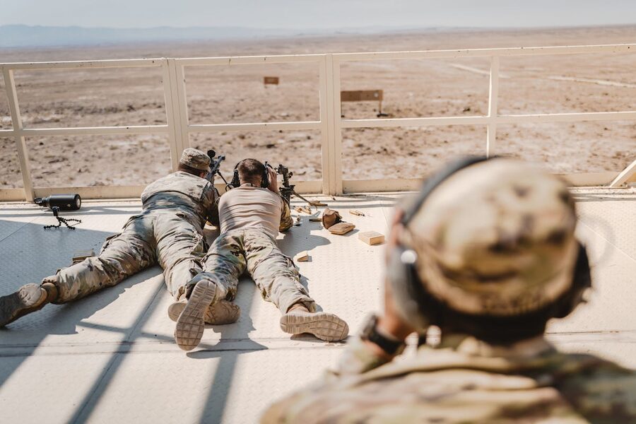 Soldiers practicing sniper skills in desert setting
