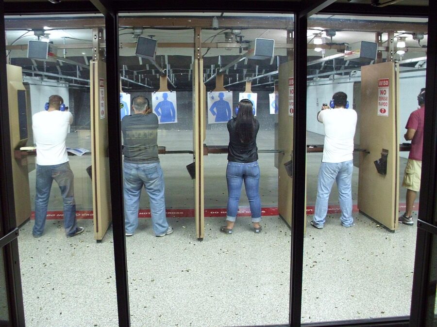 Gun range shooters aiming at targets training