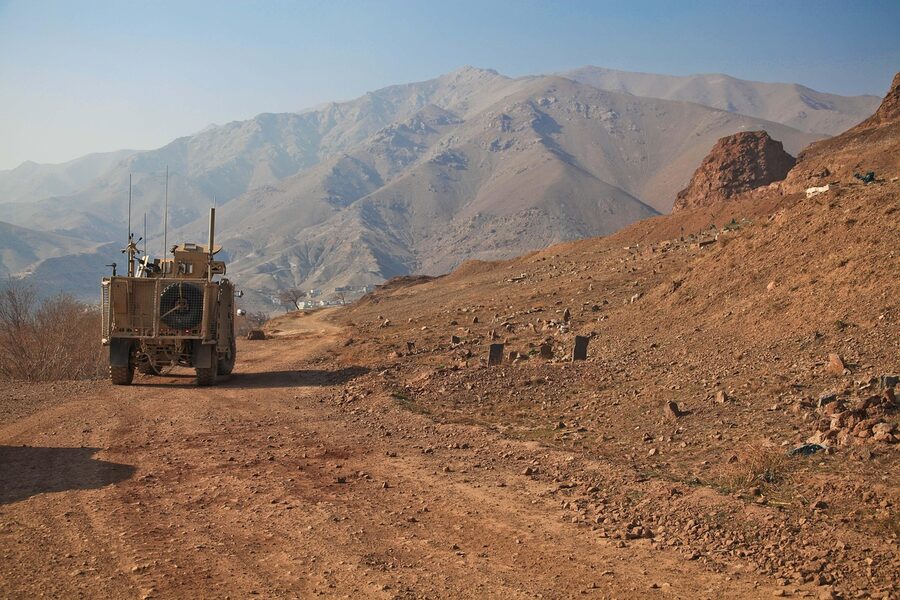Military Humvee in desert mountains convoy