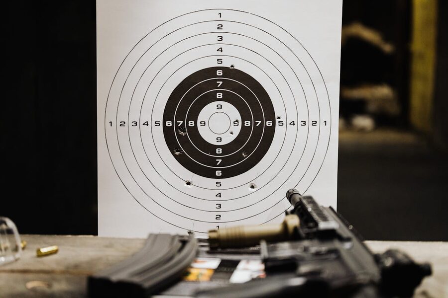 Shooting target with bullet holes on range table