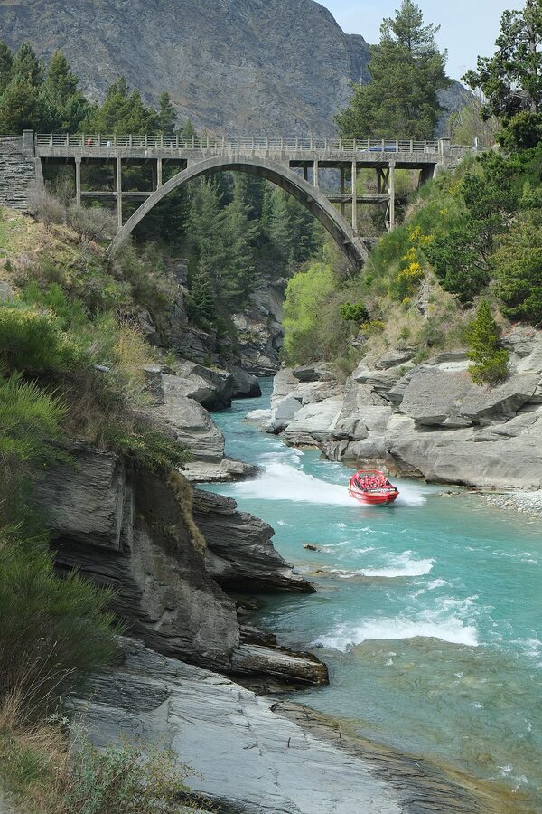 Shotover Jet boat racing under Edith Cavell Bridge at Arthur's Point