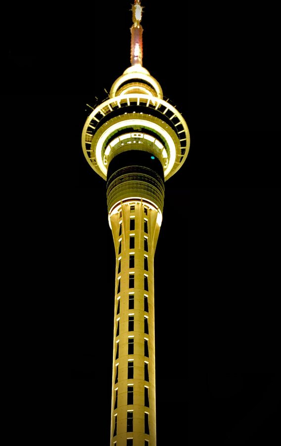 Sky Tower Auckland lit gold at night