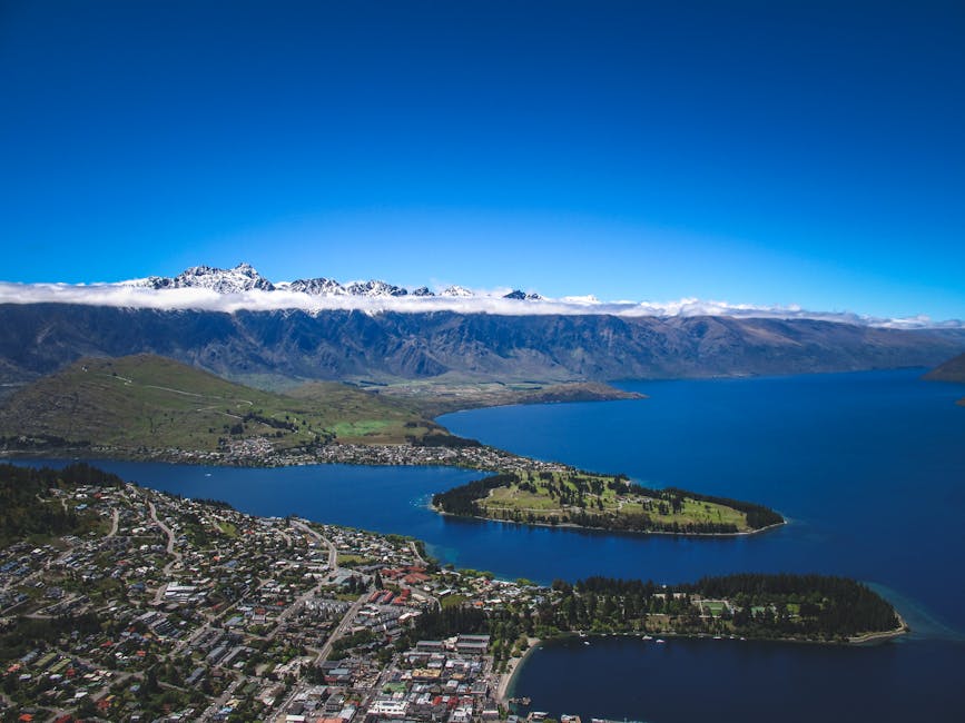 Aerial view of Queenstown with snow capped mountains and clear sky