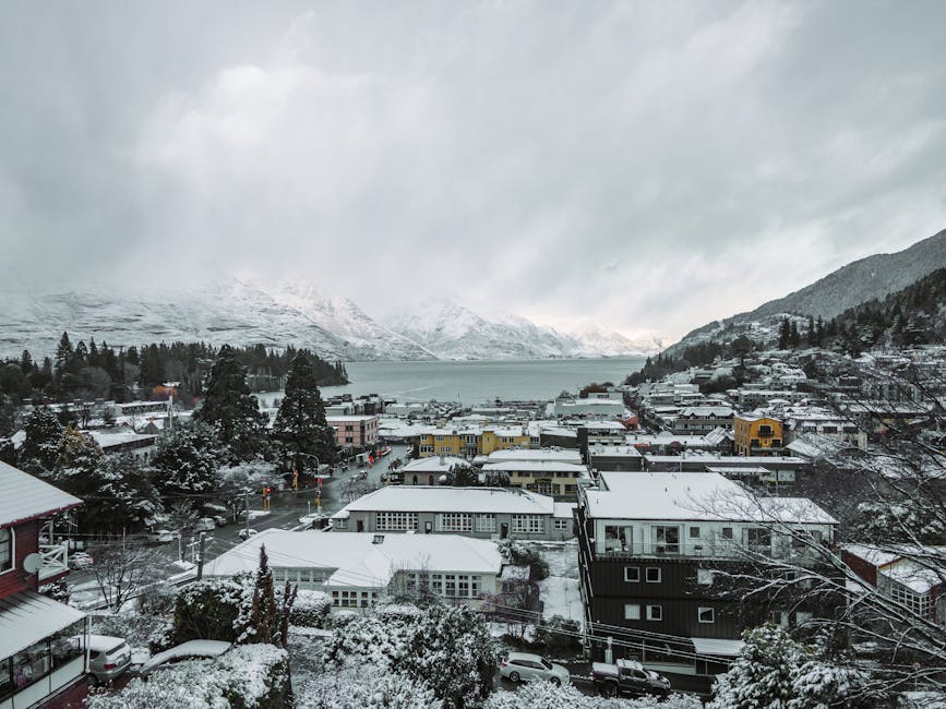 Queenstown winter aerial with snow covered buildings and Lake Wakatipu