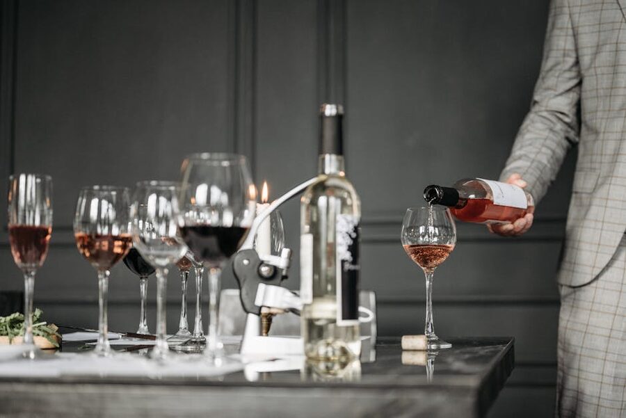 Sommelier pouring rose wine at a tasting