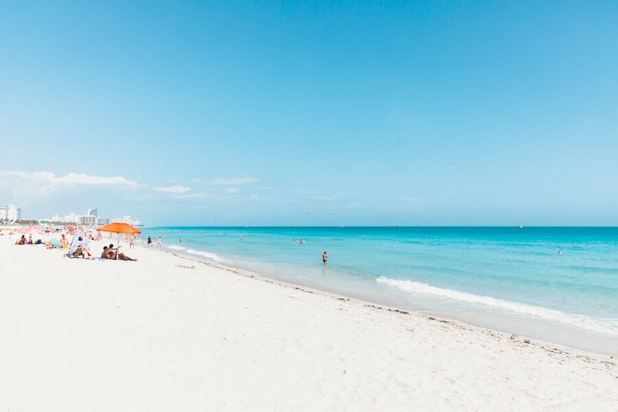 A bright day on Miami Beach with clear water and white sand