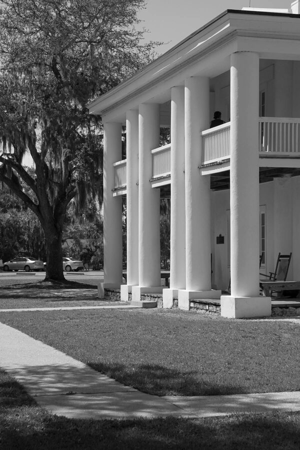Black and white photo of a Southern mansion with prominent columns
