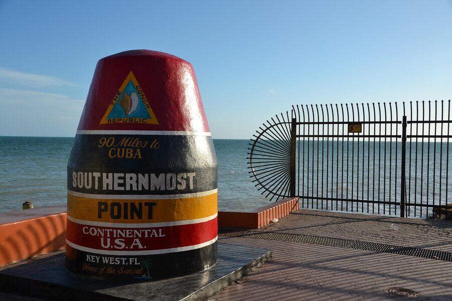 The red, yellow and black Southernmost Point buoy marker in Key West, with 90 miles to Cuba written on it