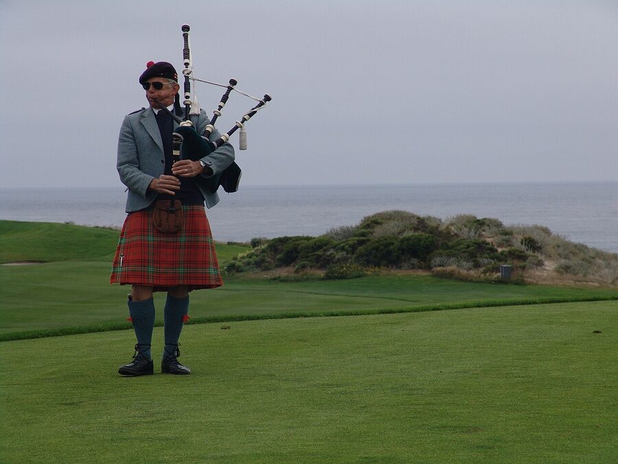 Bagpiper at Spanish Bay on Pebble Beach at sunset