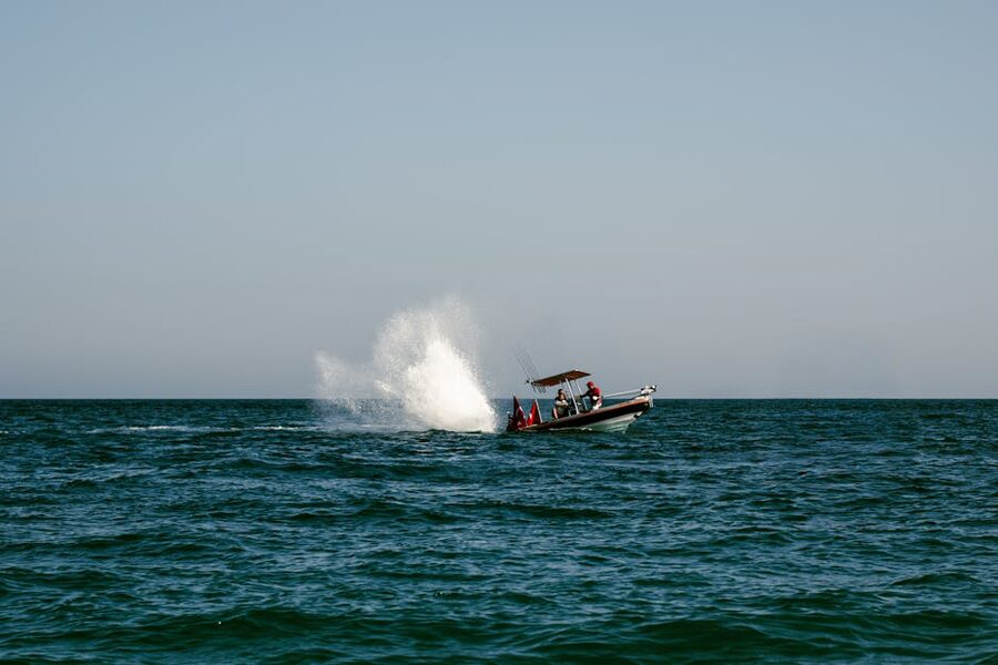 A speedboat cutting across ocean water with spray