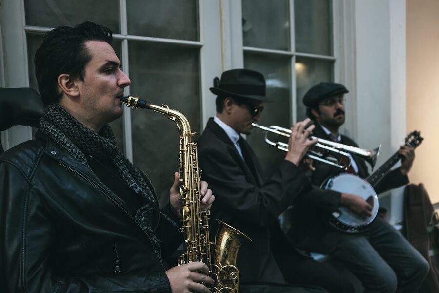 Street musicians playing saxophone trumpet and banjo in a classic jazz ensemble