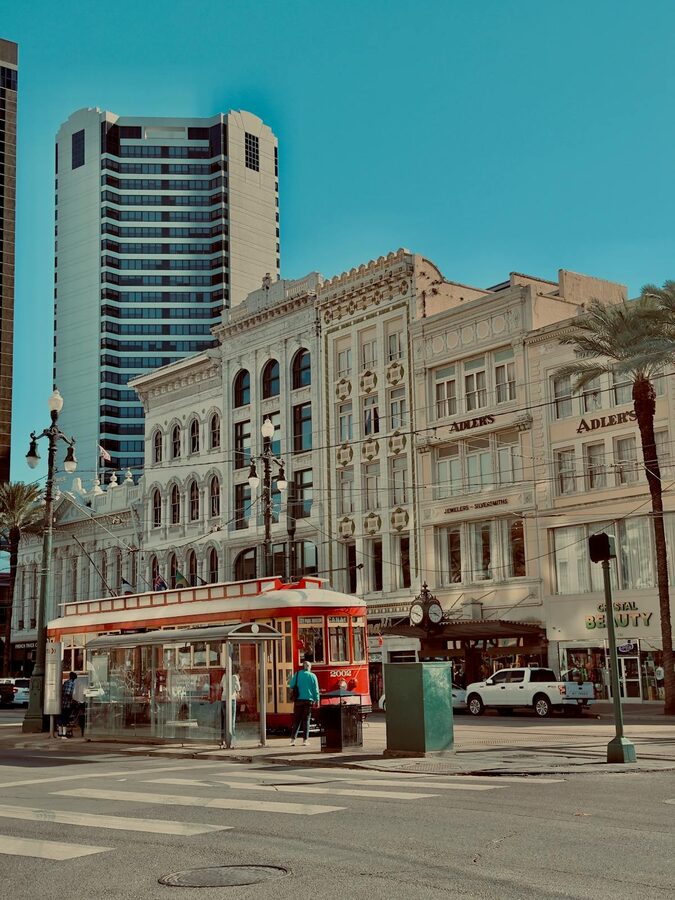 Streetcar passing historic buildings in New Orleans