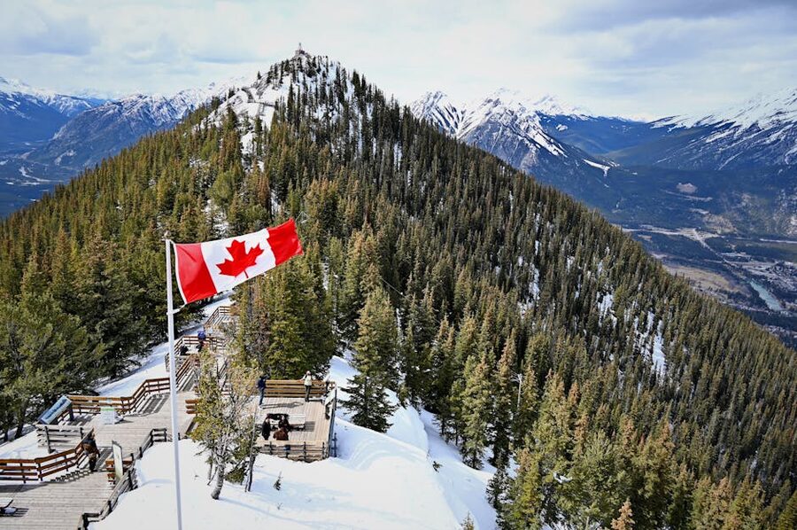 Canadian flag at Sulphur Mountain summit overlooking Banff