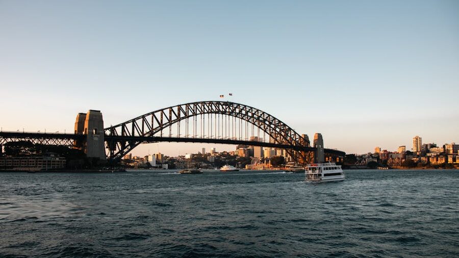 Sydney Harbour Bridge at sunset with ferry