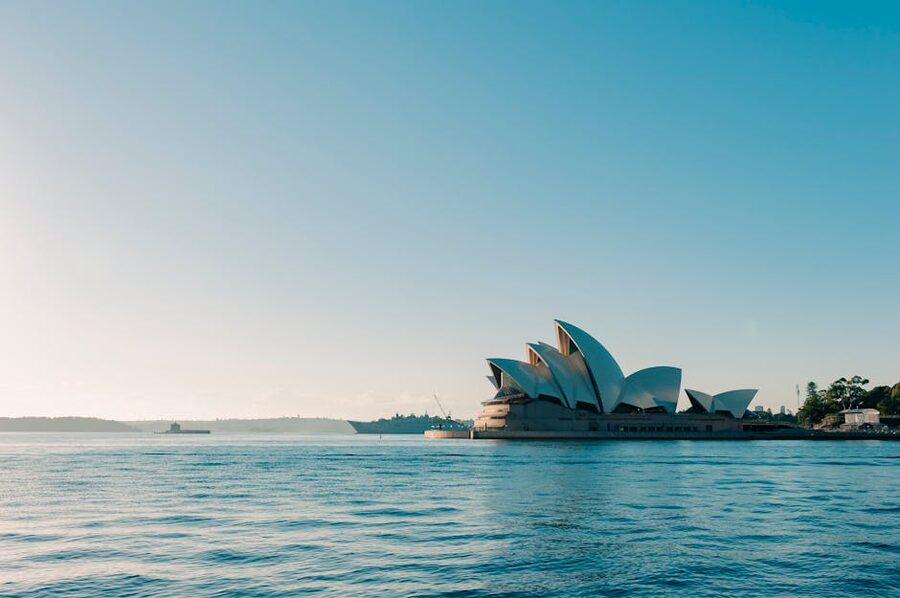 Sydney Opera House seen from the water under a clear sky