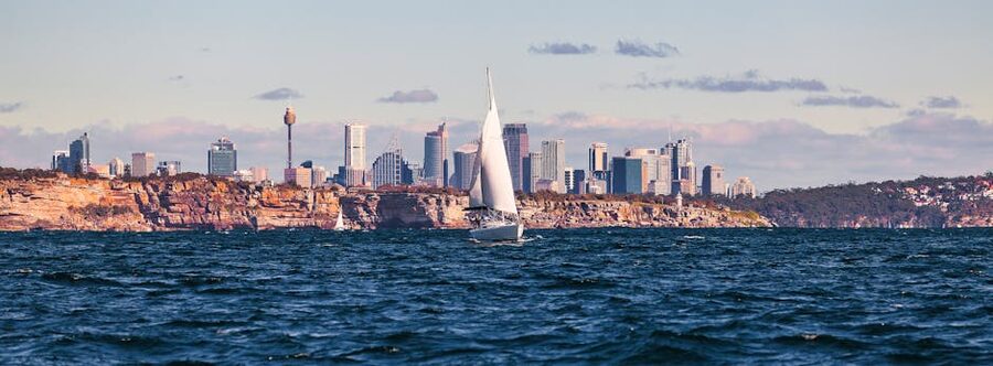 Sailboat on Sydney Harbour with city skyline