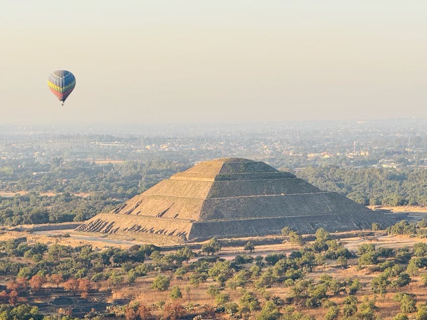 Hot air balloon floating directly above the Pyramid of the Sun
