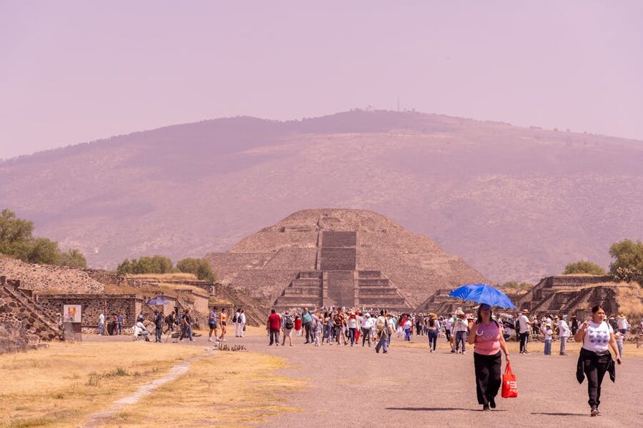 Tourists exploring the Pyramid of the Moon plaza at Teotihuacan