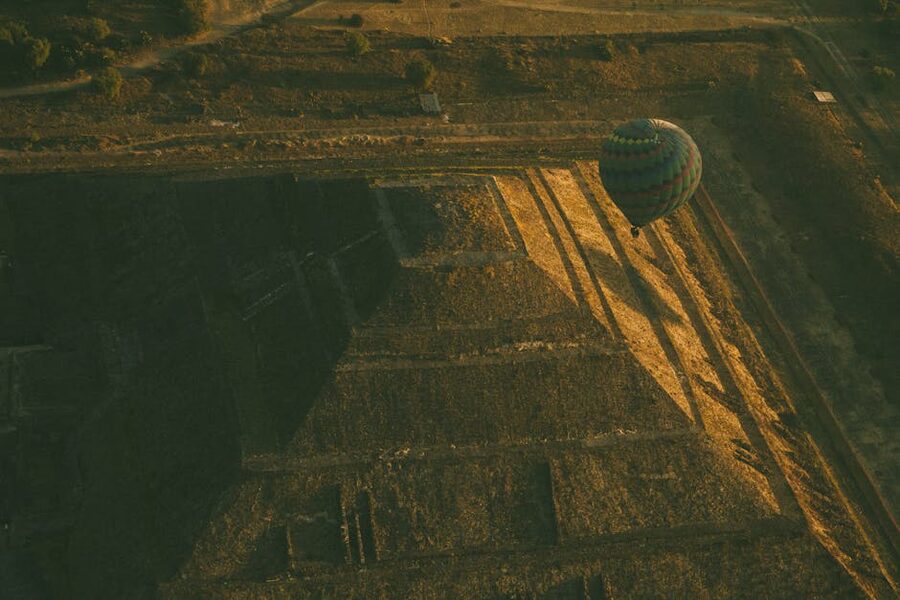 Hot air balloon floating over the Pyramid of the Sun at Teotihuacan at sunrise