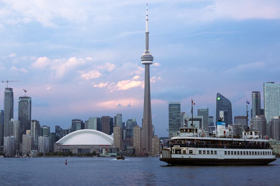 Toronto CN Tower with a ferry on Lake Ontario