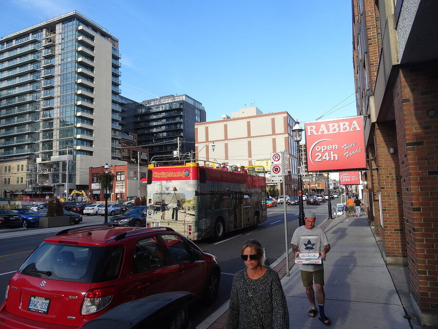 Red double-decker tour bus on Front Street in downtown Toronto