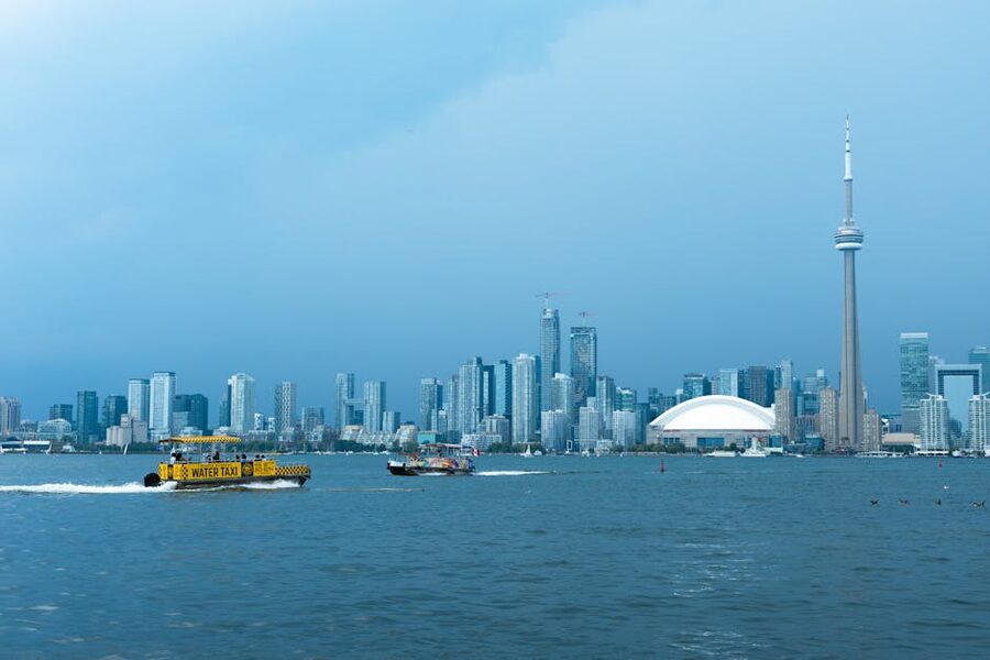 Toronto harbour with CN Tower and water taxi on Lake Ontario