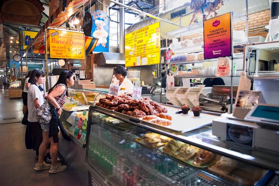 Visitors at St Lawrence Market in Toronto with food stalls