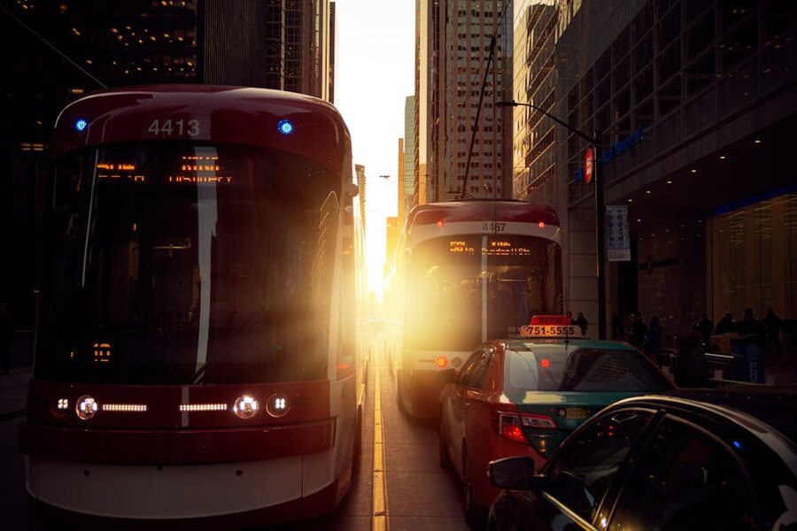 Streetcars on a busy Toronto street during sunset