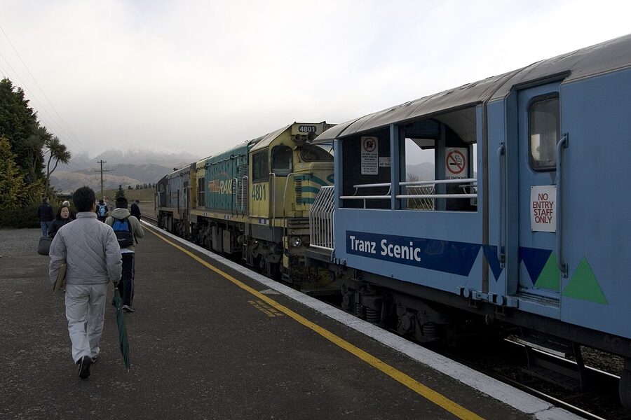 TranzAlpine open-air viewing carriage with locomotive ahead in the Southern Alps