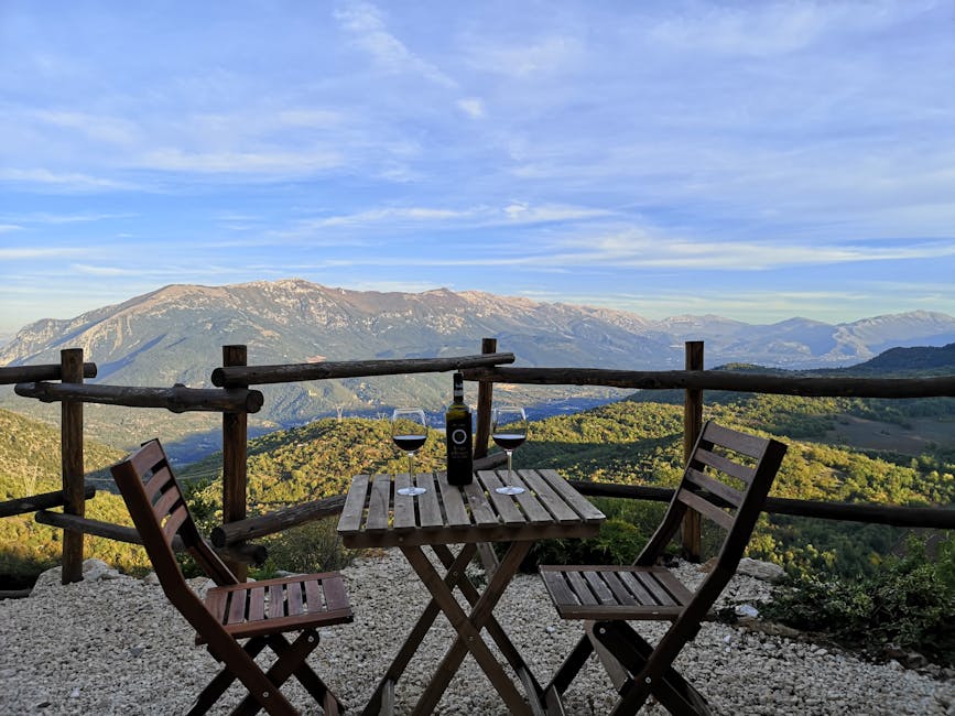 Wine on an outdoor tasting terrace overlooking a bay landscape