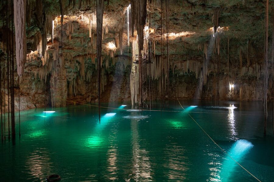 Cenote with stalactites and turquoise water in Yucatan