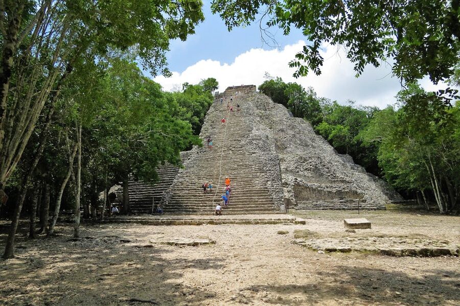 Visitors climbing Coba Mayan pyramid