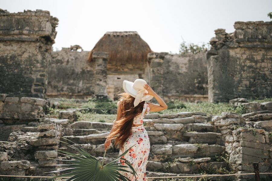 Visitor photographing the House of the Halach Uinic at Tulum