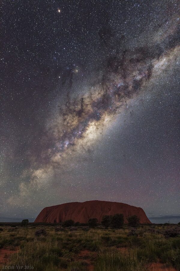 Milky Way rising over Uluru at night