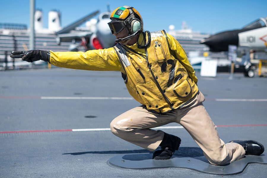 Mannequin dressed as a flight deck officer launching an aircraft on the USS Midway