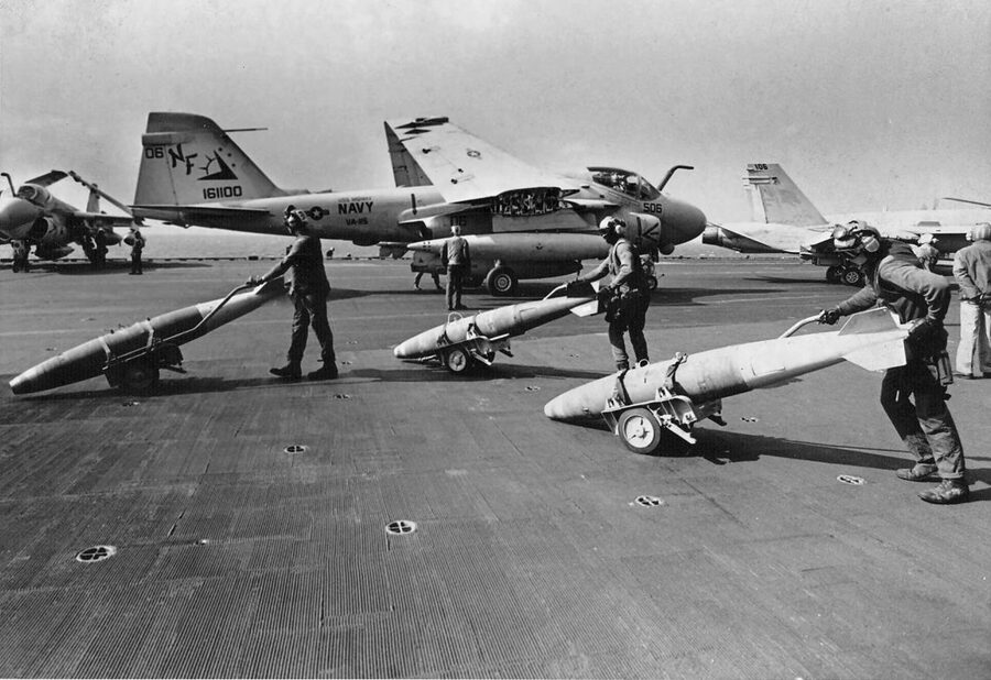 Ordnancemen push Mk 82 bombs across the USS Midway flight deck during the 1991 Gulf War
