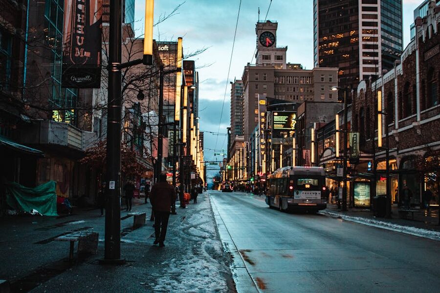 Gastown Vancouver street at dusk with a bus and clock tower