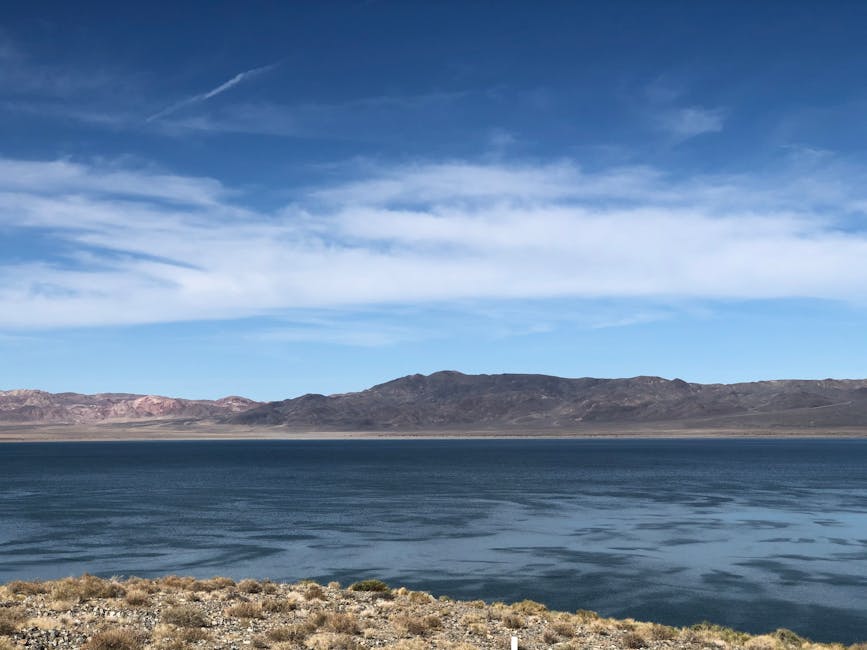 Sunlight illuminating green water inside a narrow cave from a kayak