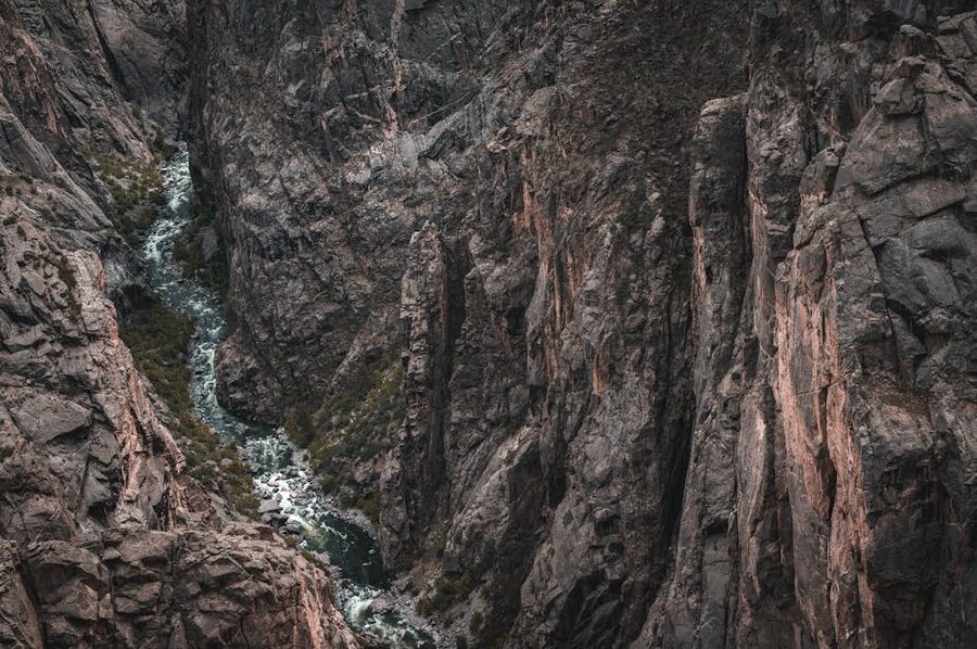 Guide leading kayak group through narrow canyon passage