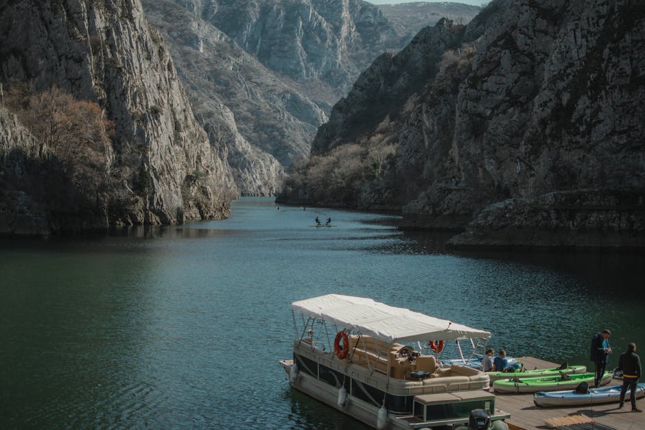 Kayaker on calm river with warm desert light hitting canyon walls