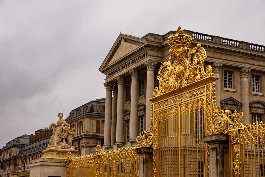 Ornate golden gates at the Palace of Versailles