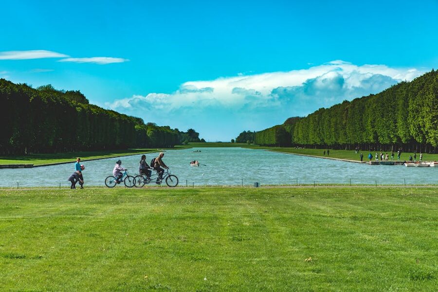 People biking and walking by the Grand Canal at Versailles