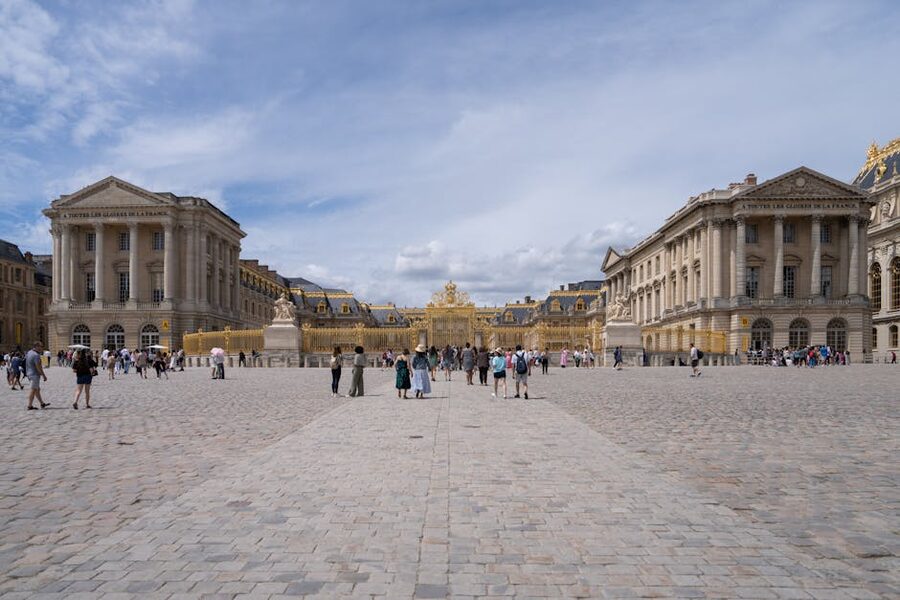 Tourists in the grand courtyard at Chateau de Versailles