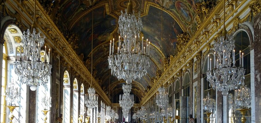 Hall of Mirrors with chandeliers and gold detail at Versailles