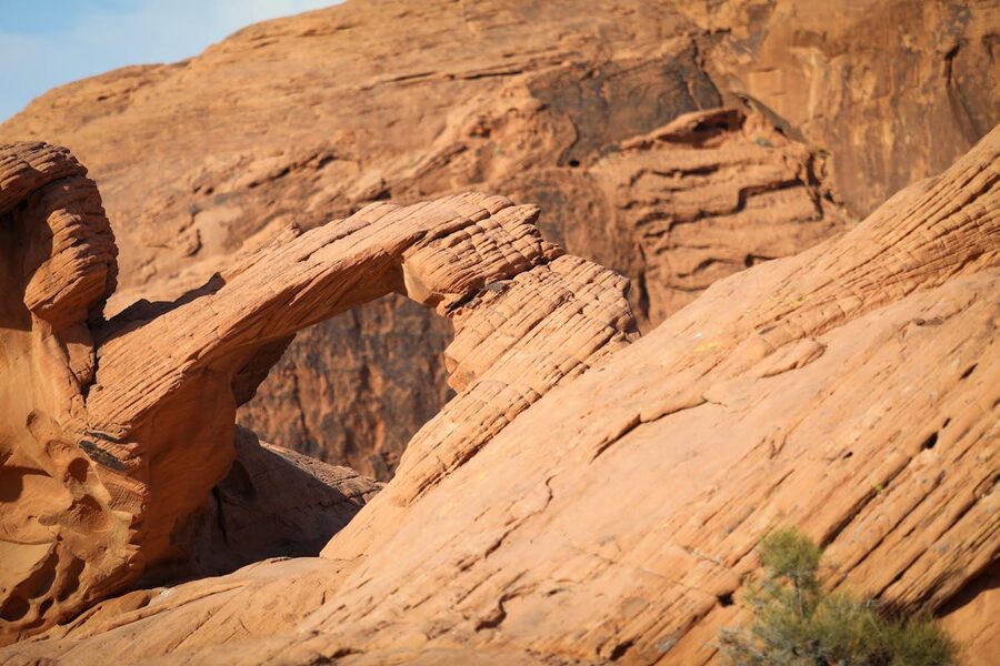 Sandstone arch surrounded by rugged rock formations in Valley of Fire Nevada