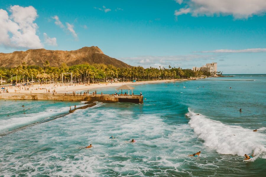 Waikiki Beach and Diamond Head with surfers and clear blue skies