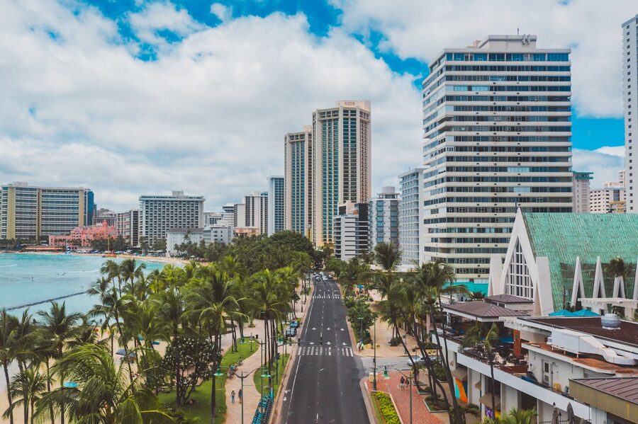 Aerial view of Waikiki beachfront with skyscrapers and palm trees