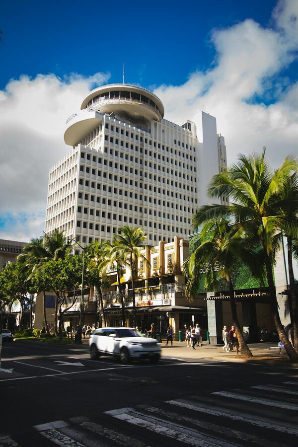 Dynamic street scene featuring the Top of Waikiki restaurant in Honolulu